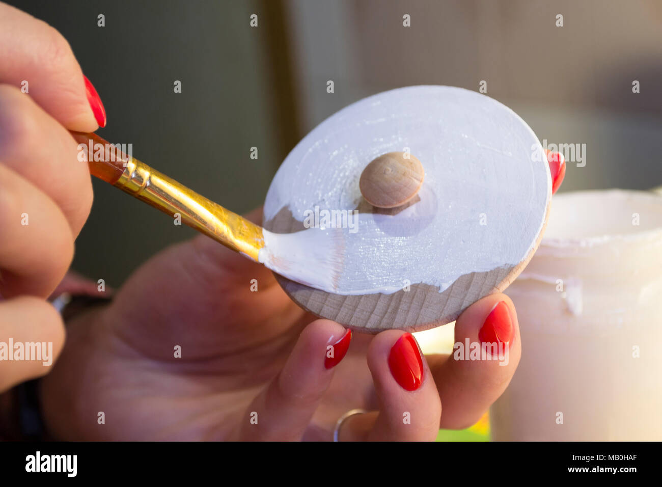 Woman painting wooden cap in white. Handmade, diy, Closeup photo Stock ...