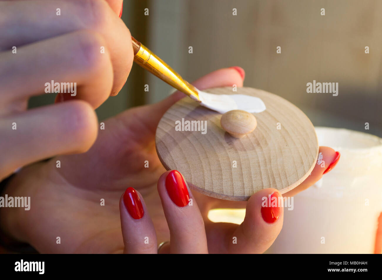 Woman painting wooden cap in white. Handmade, diy, Closeup photo Stock ...