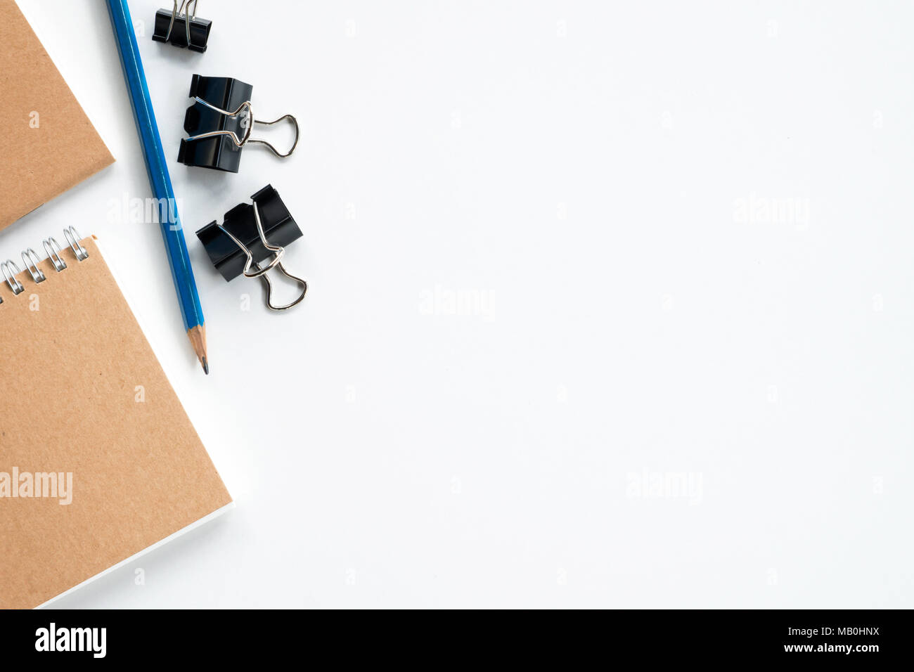 White student's desk table with notebooks and supplies. Top view with ...