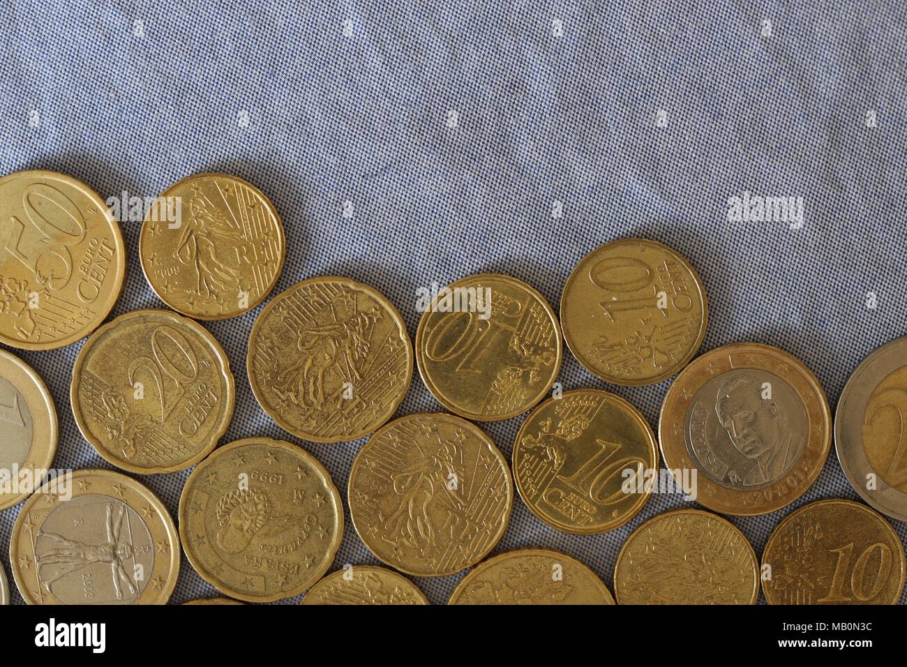 Small denomination European Euro coins on a blue background Stock Photo ...