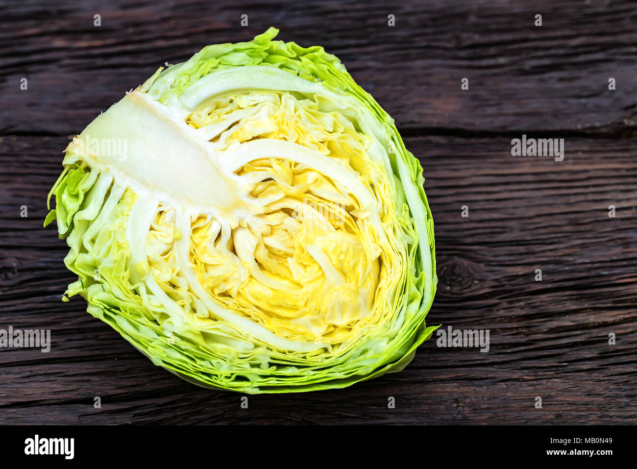 Half of fresh cabbage head on wooden surface Stock Photo - Alamy