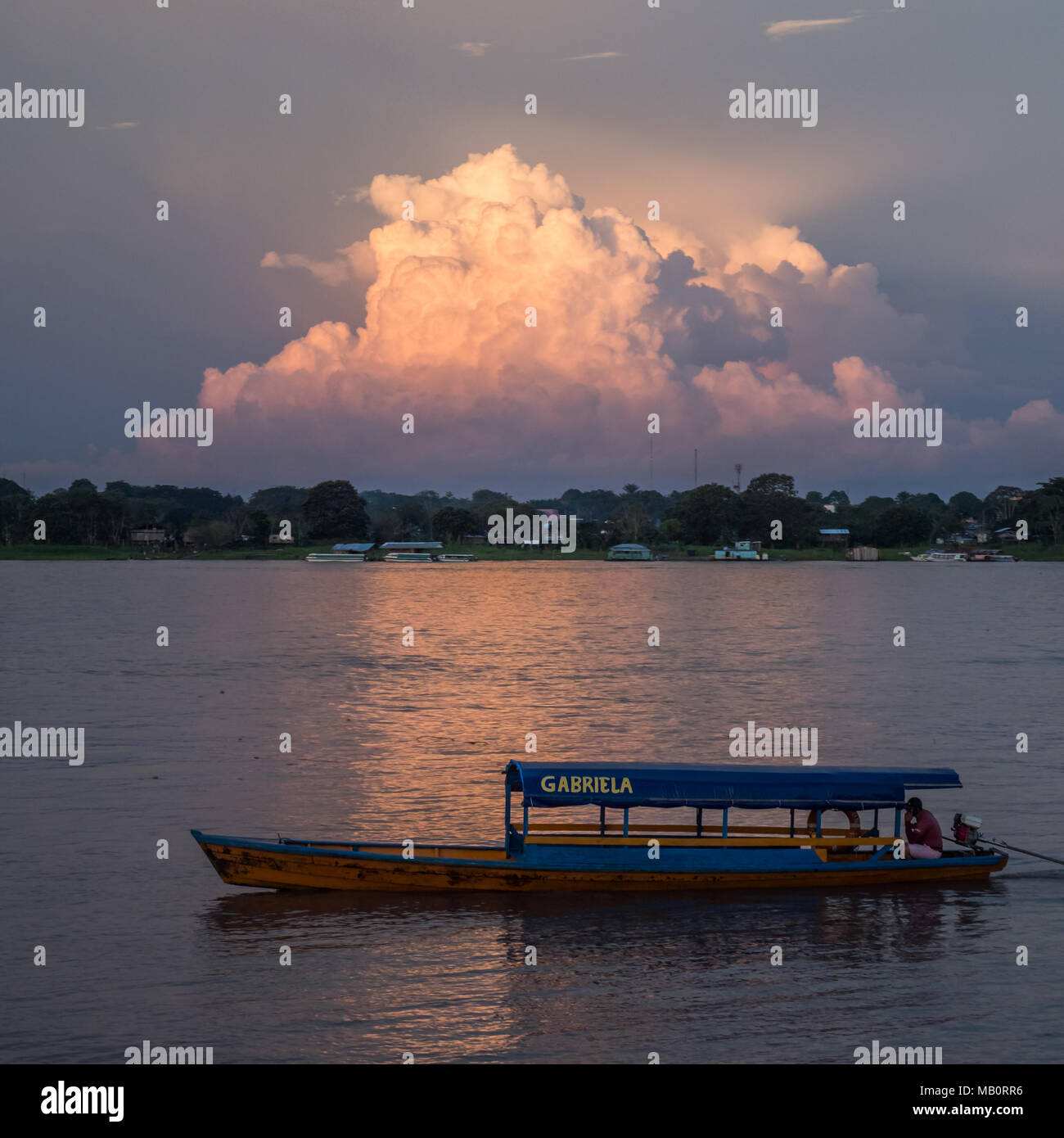 Santa Rosa, Peru - Mar 24, 2018: Sunset over the Amazon river the cargo ...