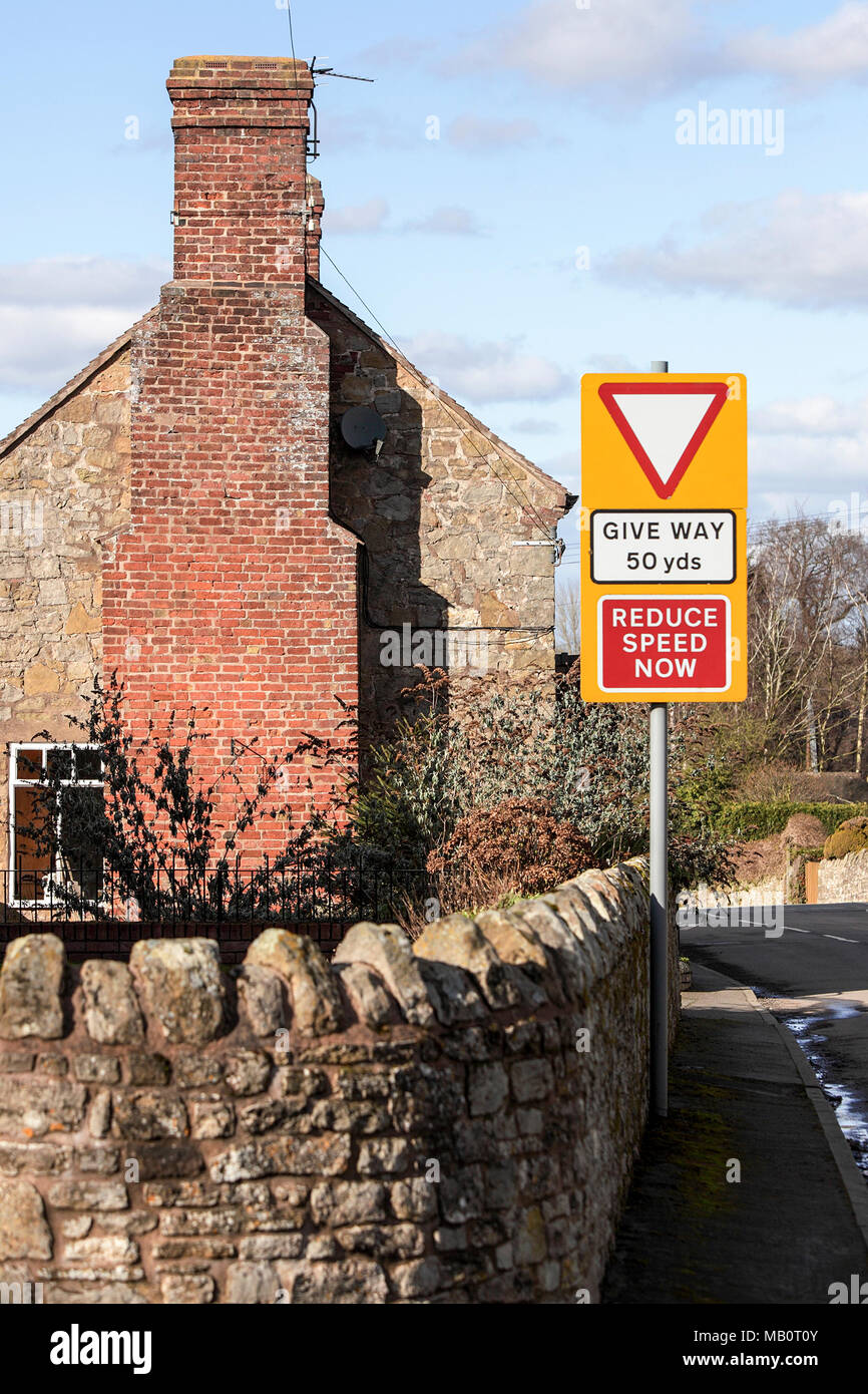 Gable-end of country cottage with an soft focused street sign Stock ...
