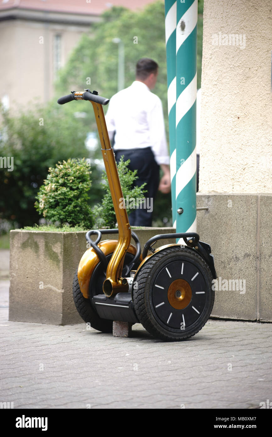 An electric stool parked next to a building in the city Stock Photo - Alamy