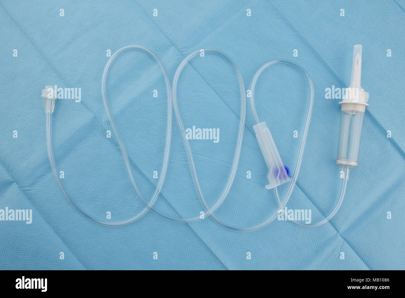 Medical drip on a blue fabric Stock Photo - Alamy