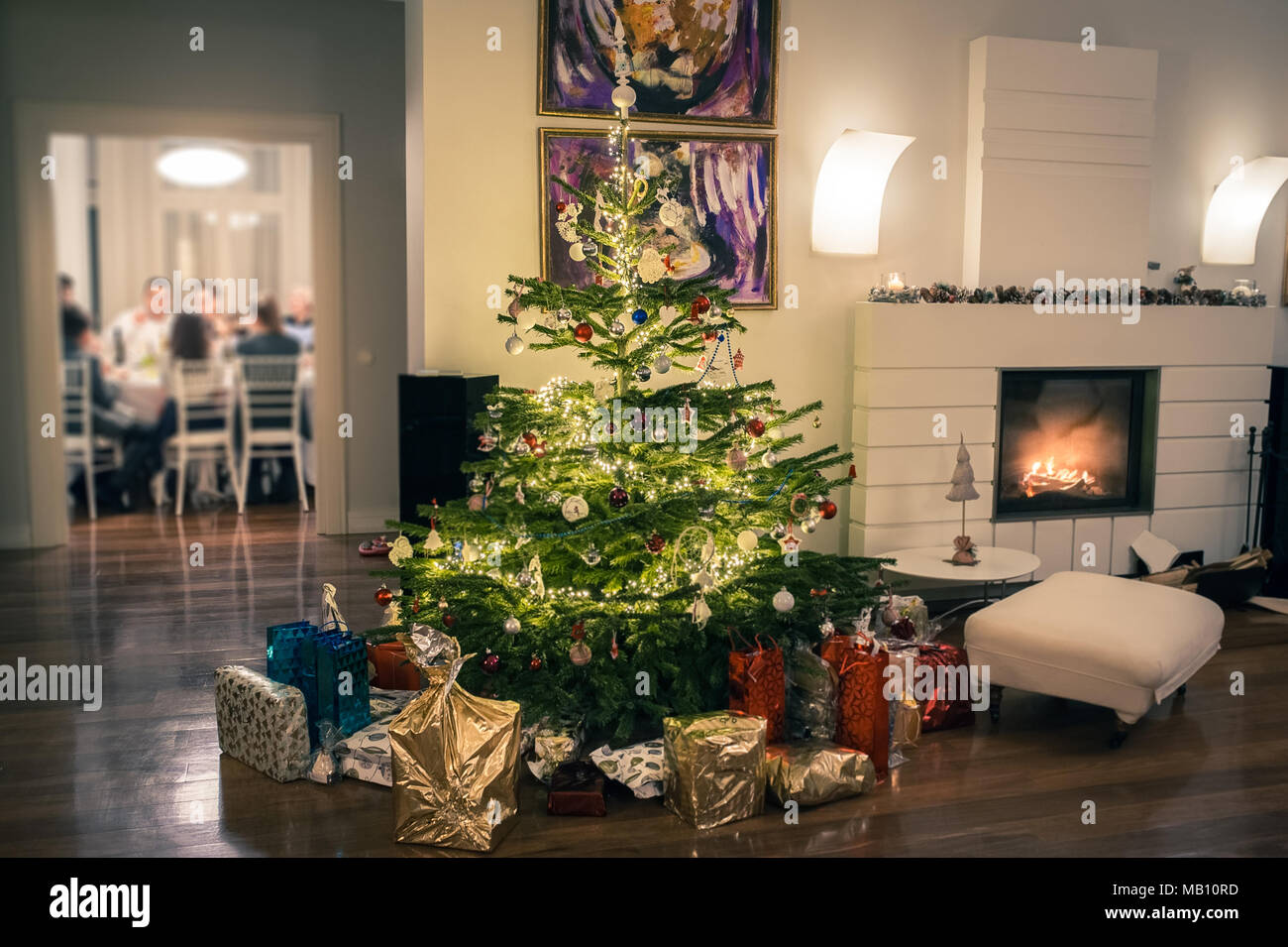 Christmas tree and family having dinner Stock Photo - Alamy