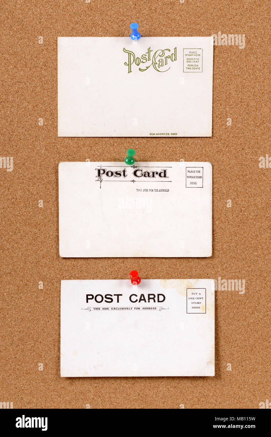 Old stained and faded postcards on a cork bulletin board Stock Photo ...