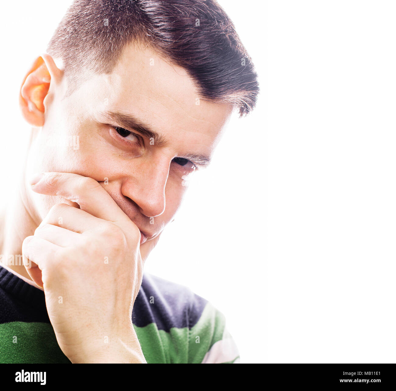 Portrait of a smart serious young man standing against white bac Stock ...