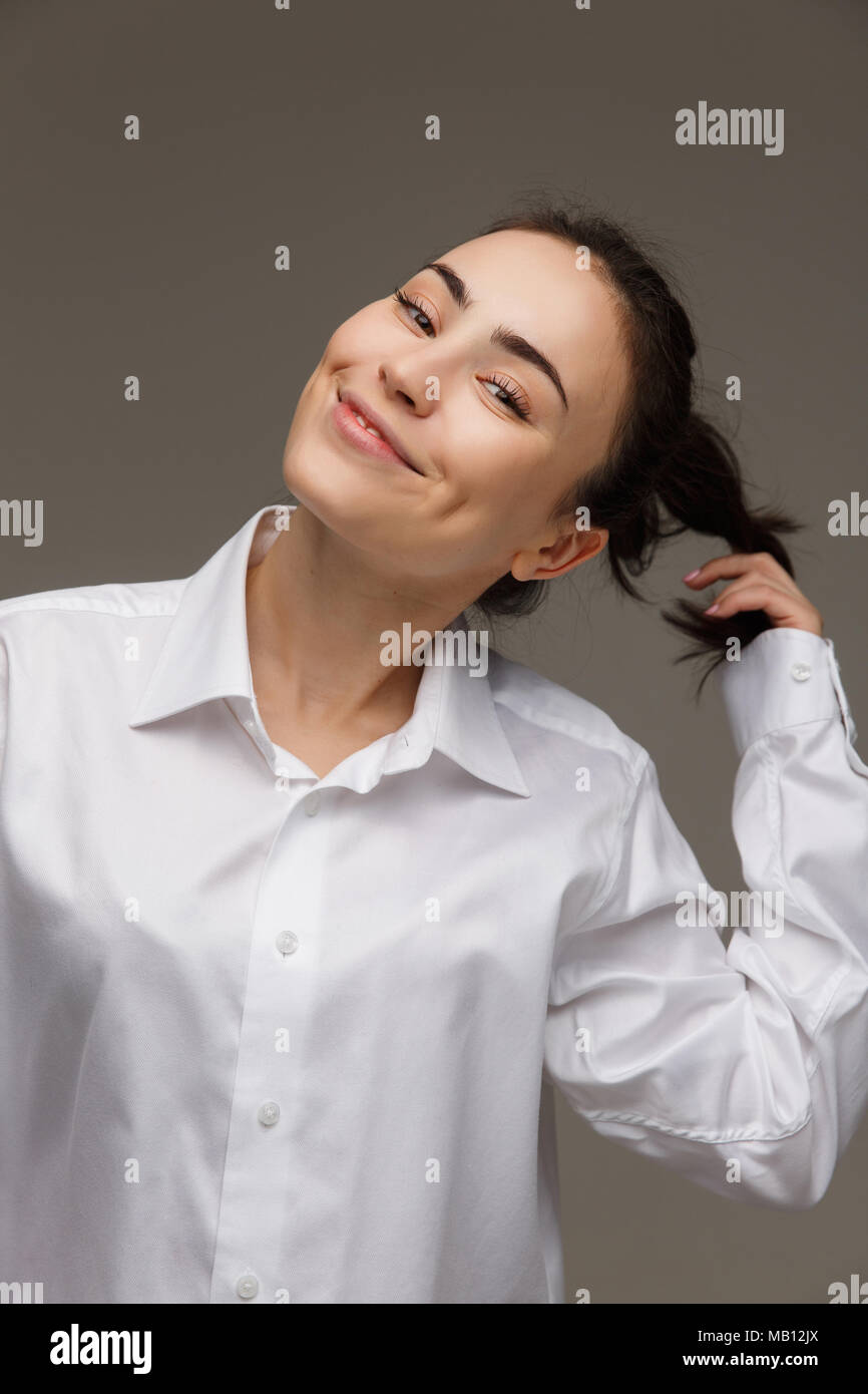 Beautiful girl in a white shirt shows emotions - smile, fun Stock Photo ...