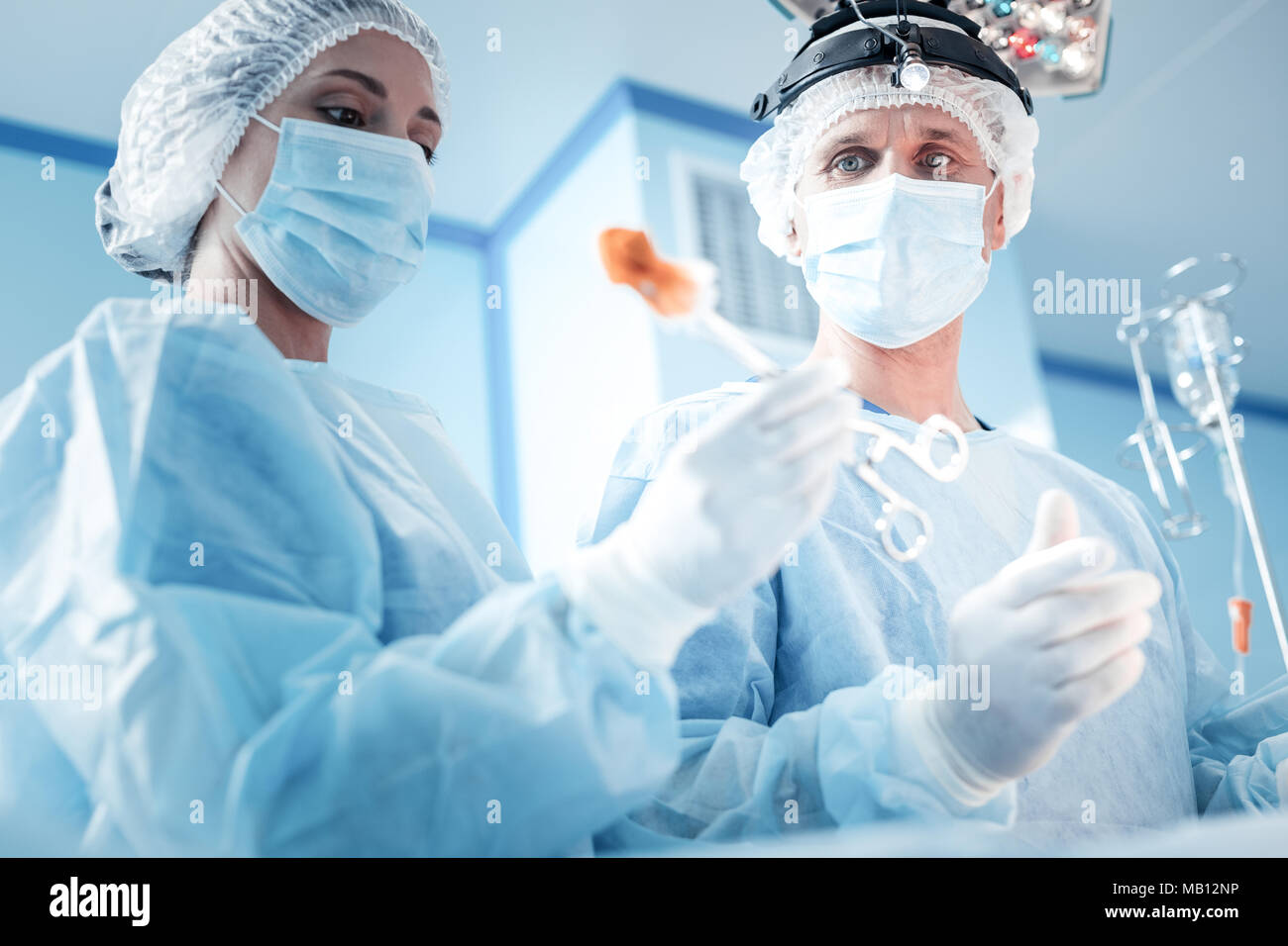 Professional smart doctors performing a surgery Stock Photo - Alamy