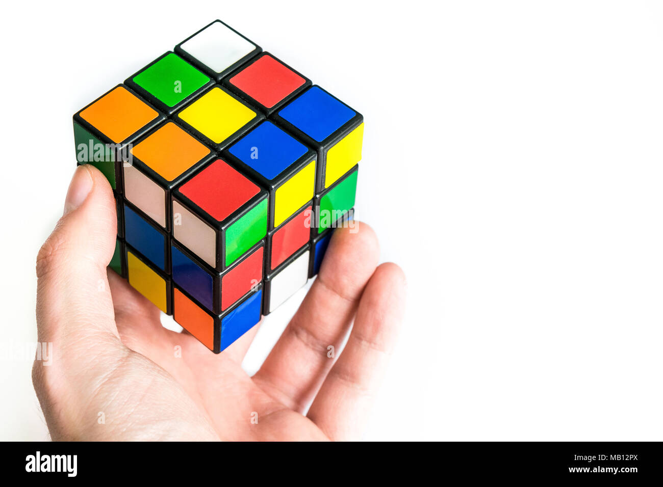 Hand with a Rubik's cube Stock Photo - Alamy