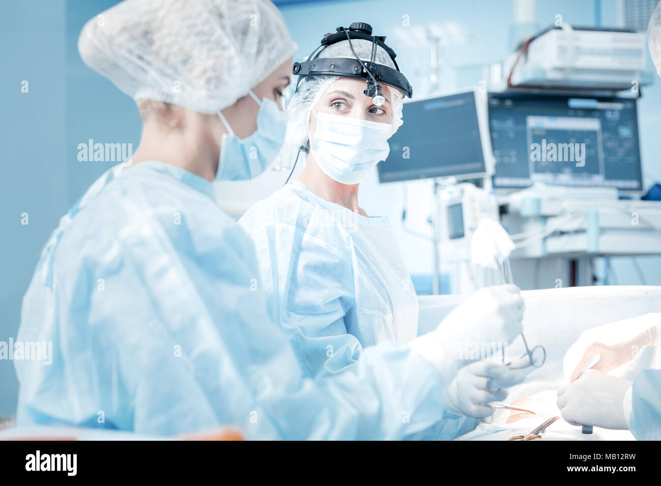 Smart nice doctor standing near her colleague Stock Photo - Alamy