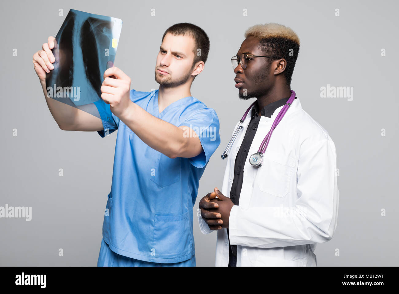 Doctor and surgeon examining x-ray film of patient 's injury Stock ...