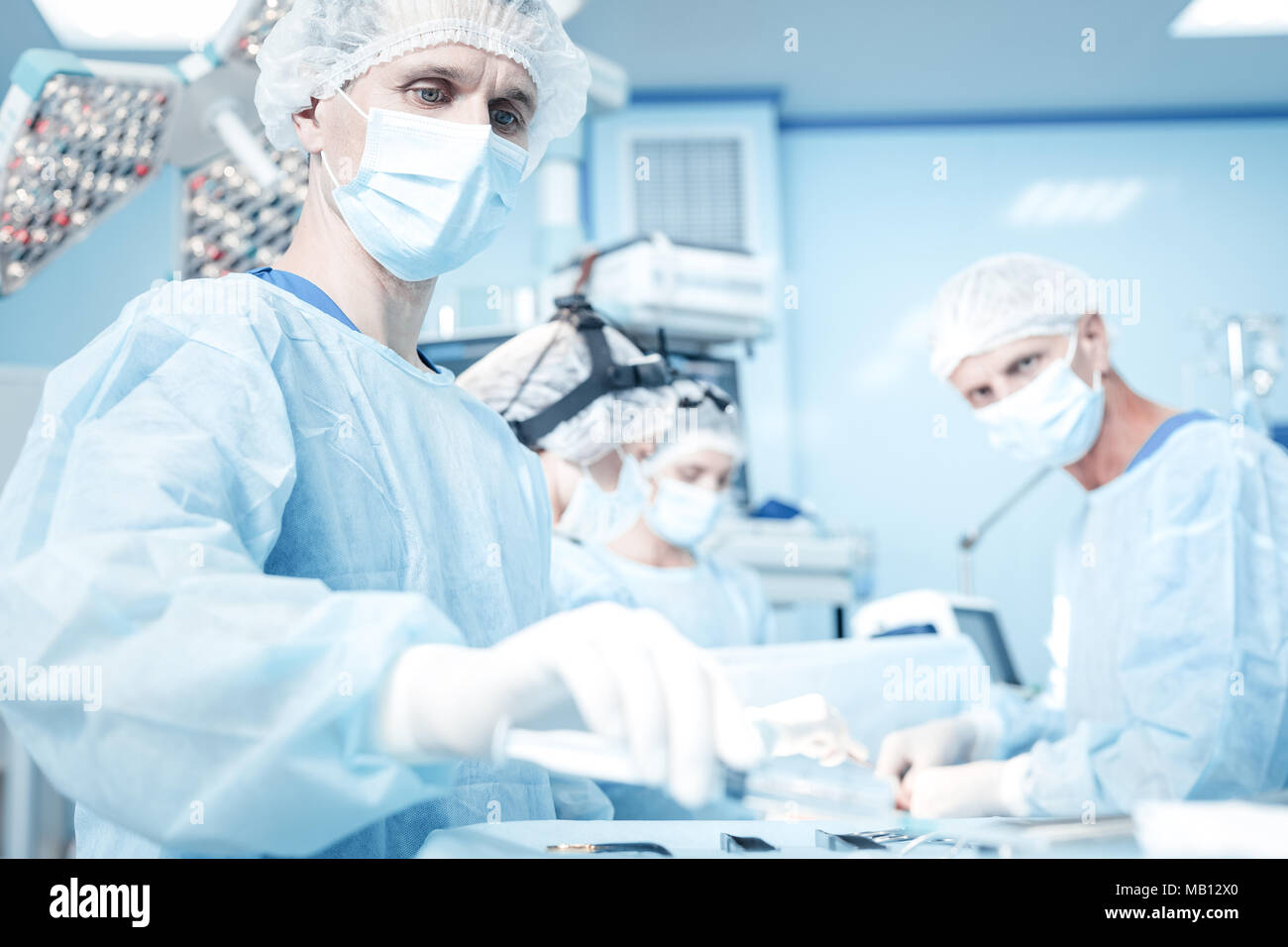 Surgeon holding surgical instruments hi-res stock photography and ...