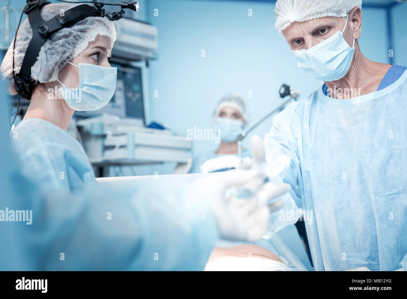 Nice skilled surgeons working together Stock Photo - Alamy
