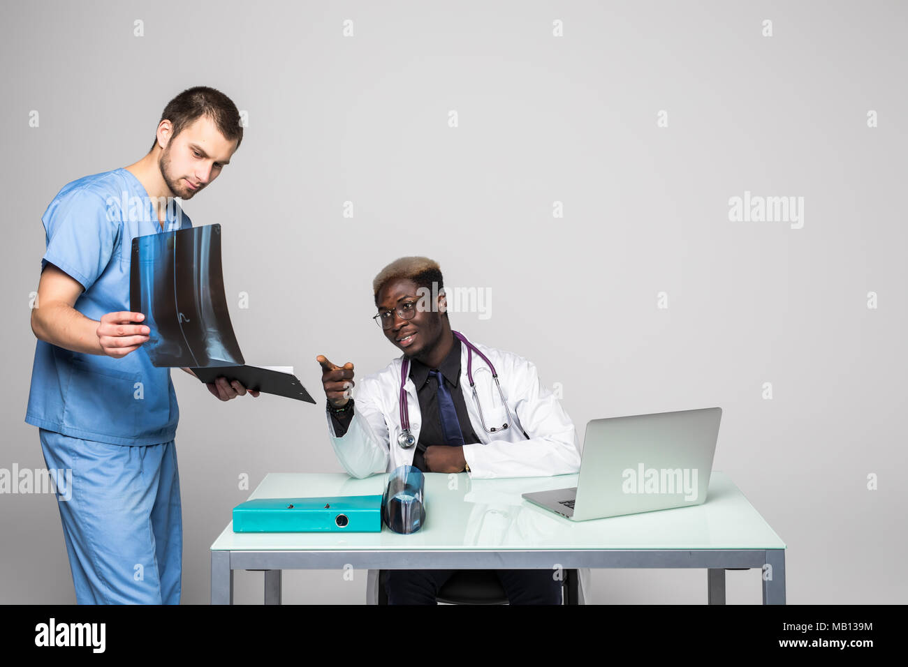 Young doctors discussing diagnosis in bright office. Two doctors ...