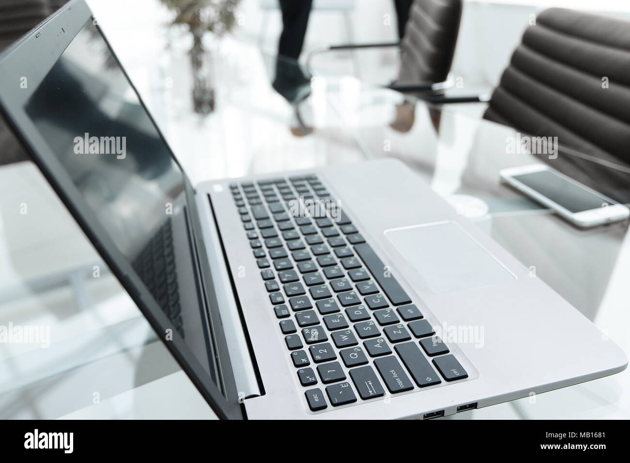 laptop and a smartphone on the desktop in the conference room Stock ...