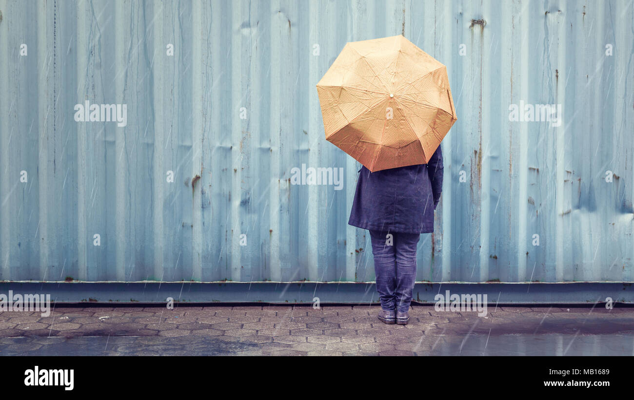 Back view of a woman holding an umbrella Stock Photo - Alamy