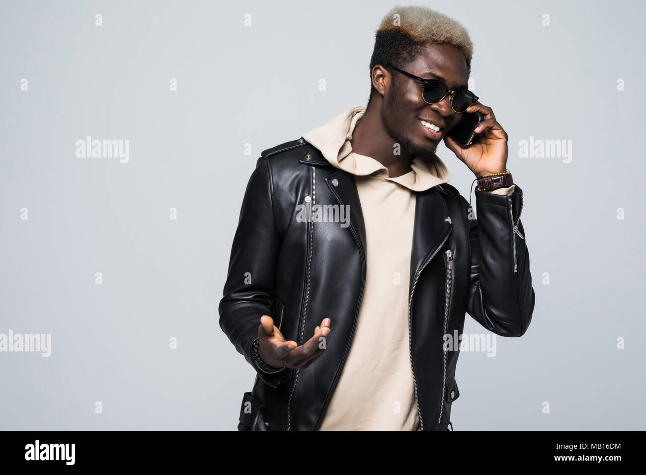 Young African American man making a phone call on her smartphone ...