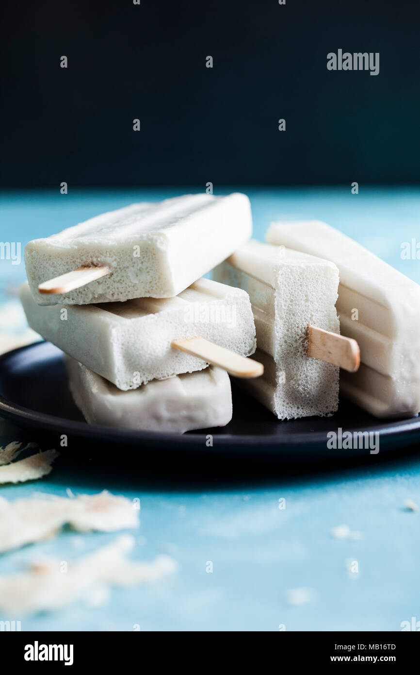 Popsicle sticks on plate with dark background Stock Photo - Alamy