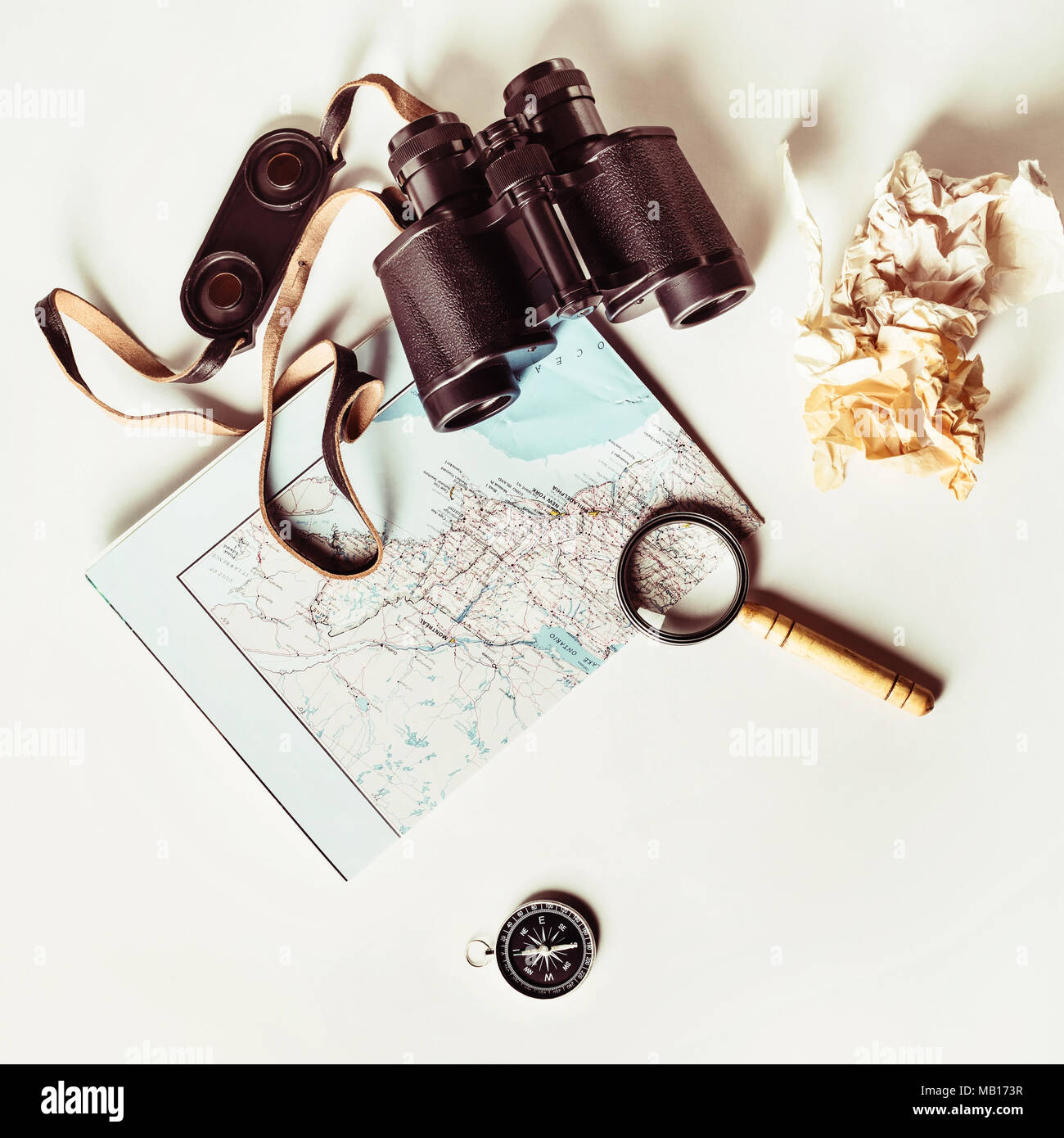 Travel still life. Map, binoculars, compass, magnifier and crumpled ...