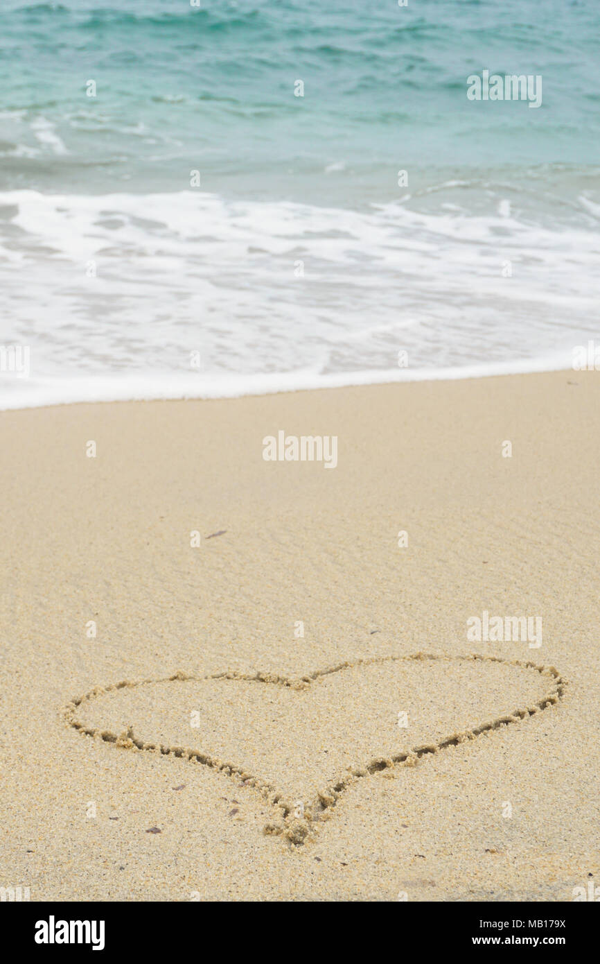 Heart shape drawn in sand on beach with sea wave Stock Photo - Alamy