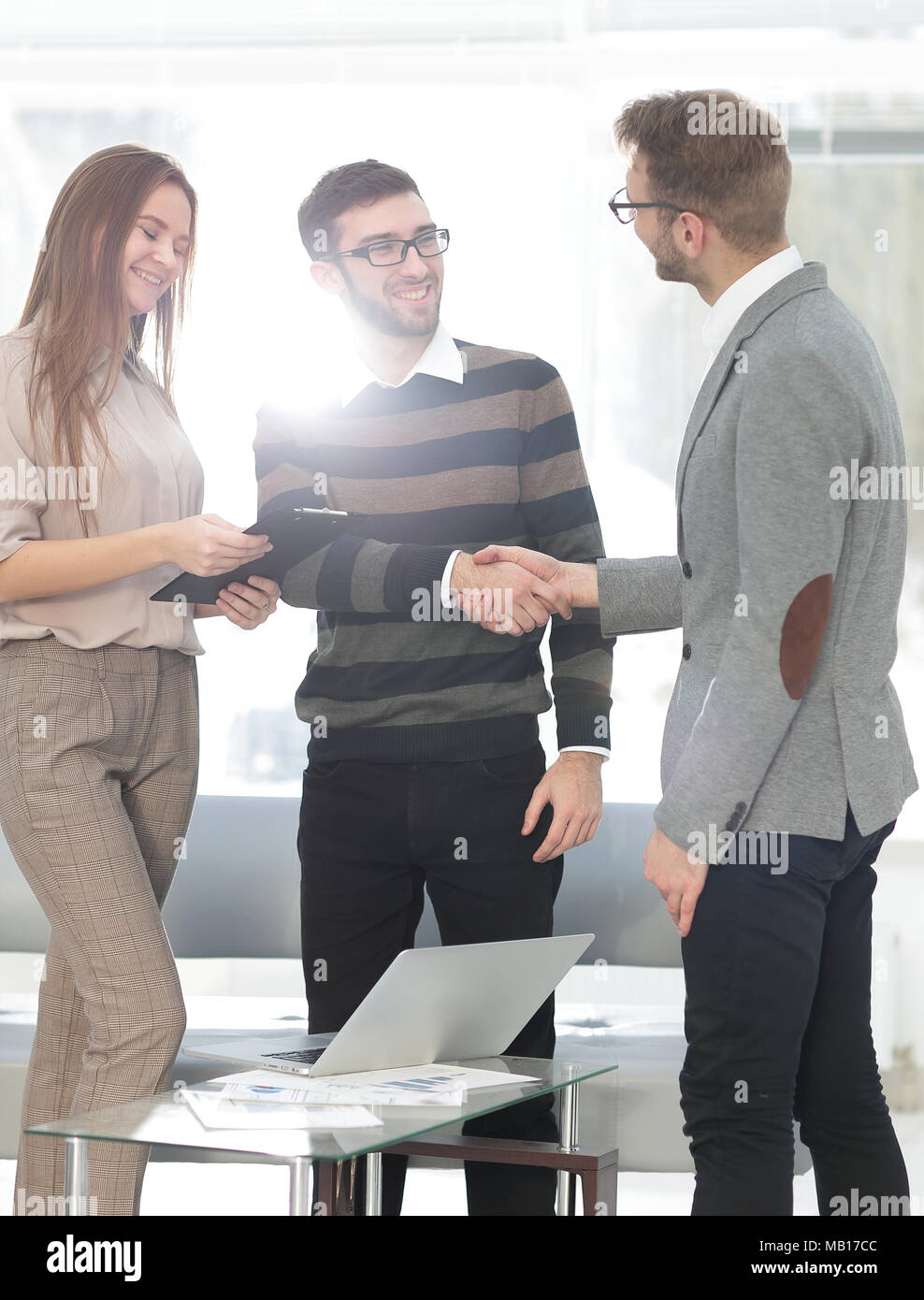 Friendly handshake between colleagues hi-res stock photography and ...