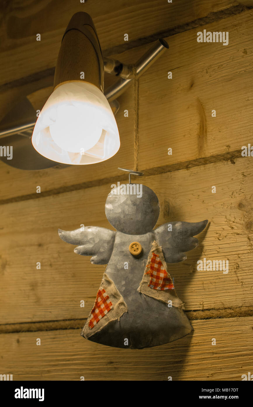 Metal angel hanging on the lamp Stock Photo - Alamy