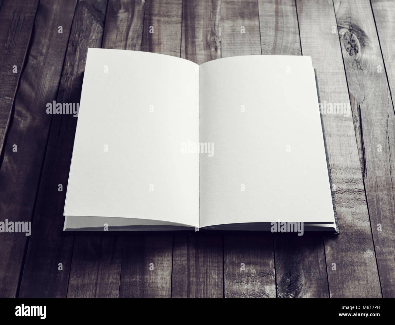 Blank open book on wooden table background. Mock up for placing your ...