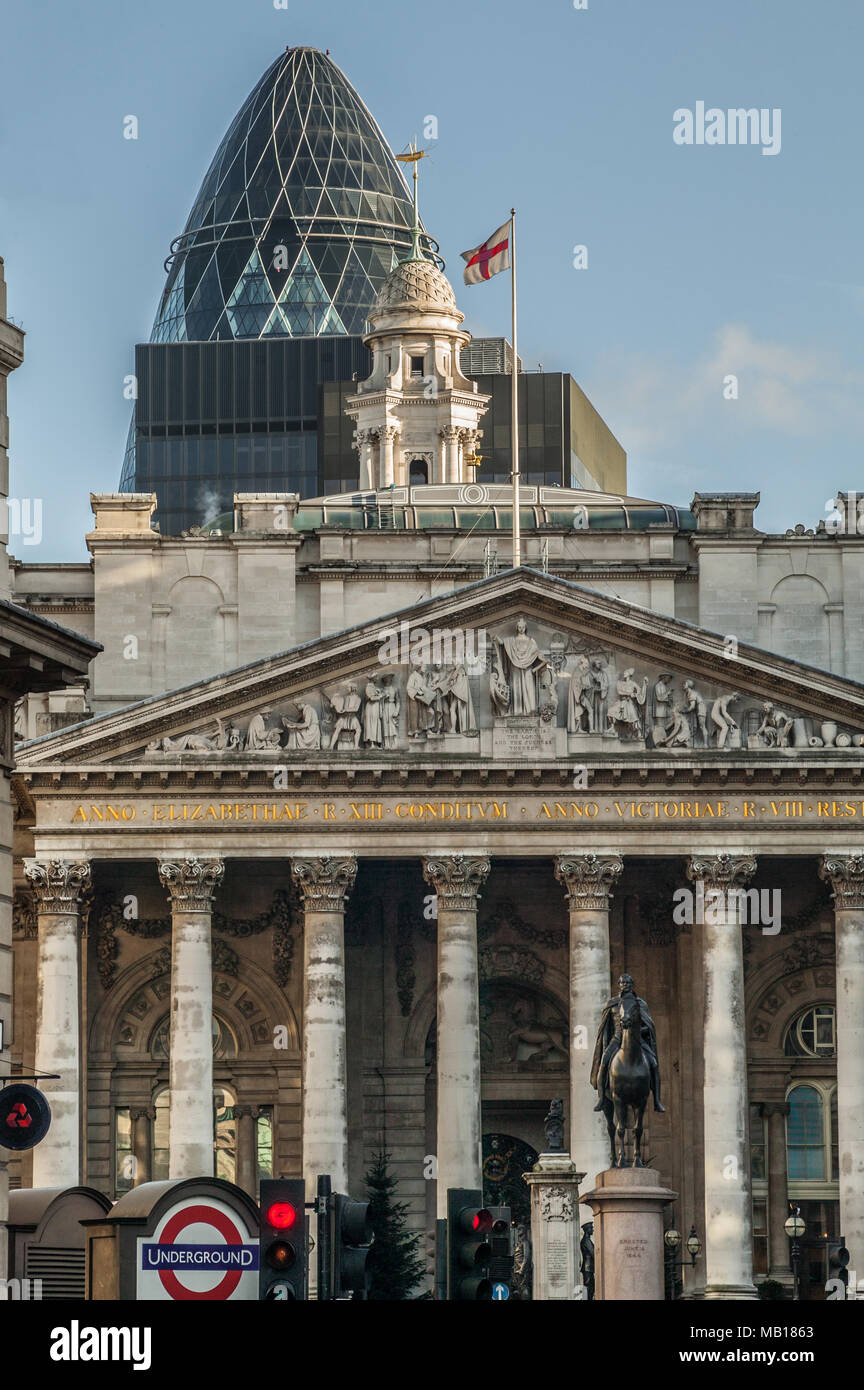 The facade of the Royal Exchange in London. Behind the Gherkin building ...