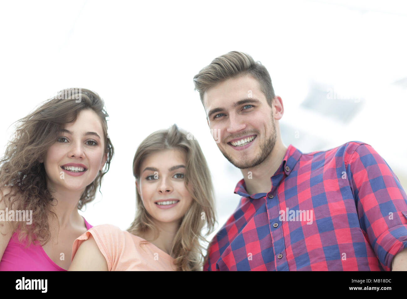 closeup of three young people smiling on white background Stock Photo ...