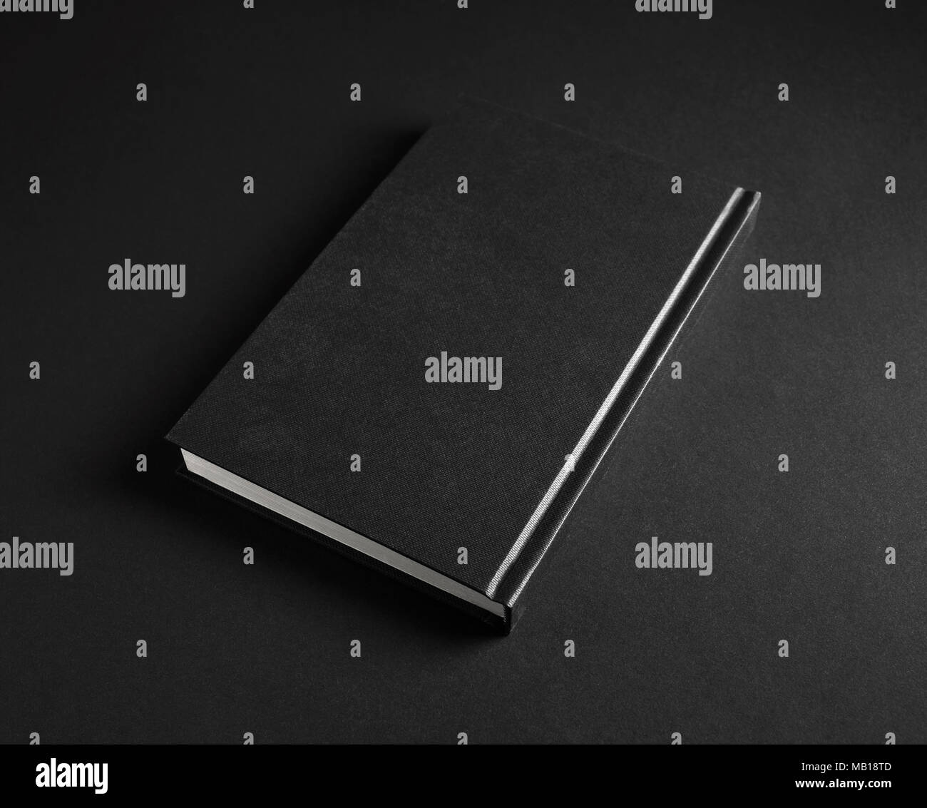 Blank black hardcover book on black paper background Stock Photo - Alamy