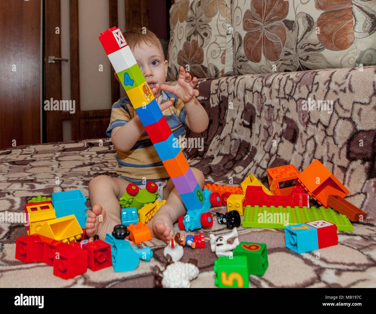 Sweet little boy building tower from cubes at home Stock Photo - Alamy