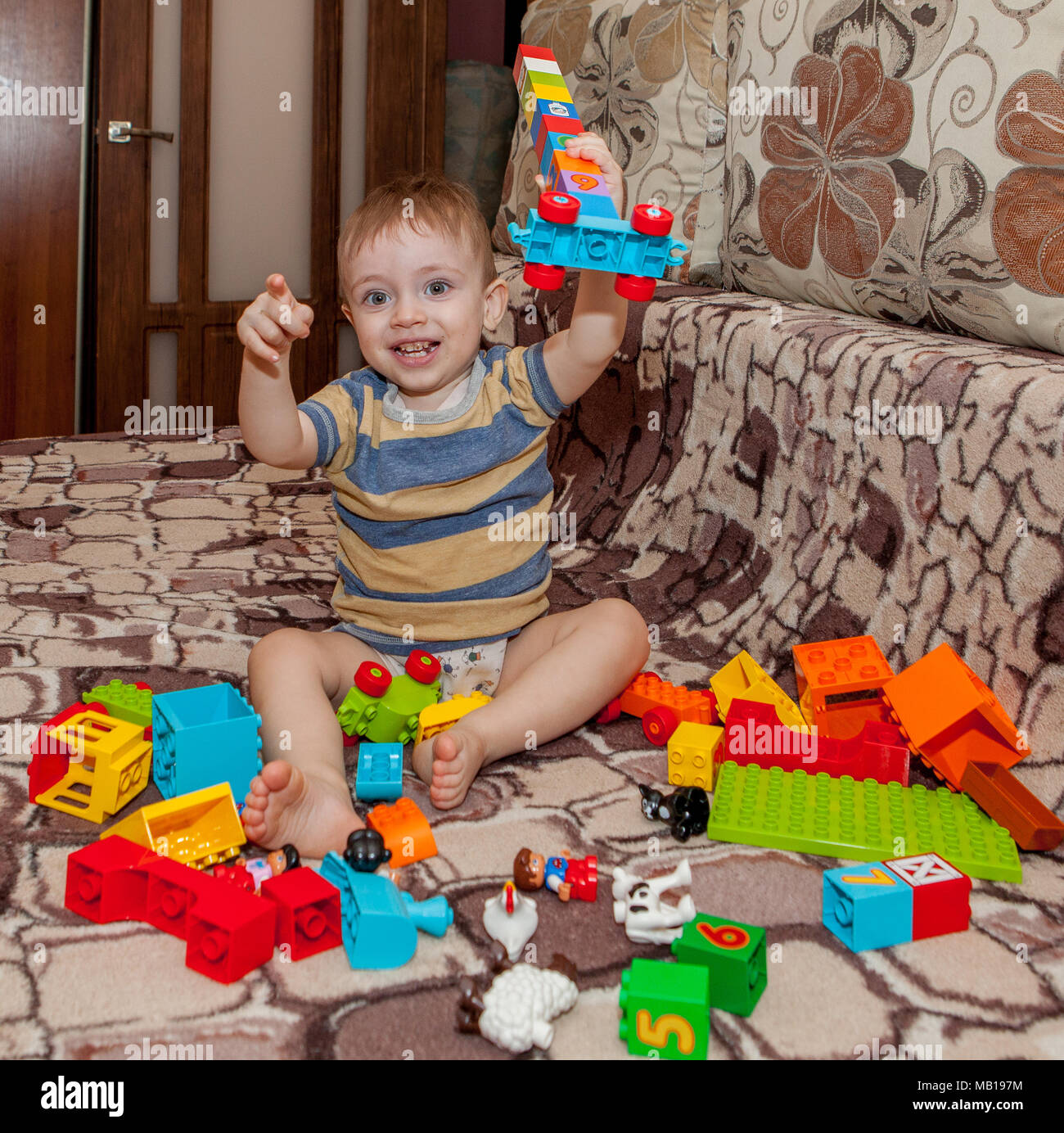 Sweet little boy building tower from cubes at home Stock Photo - Alamy