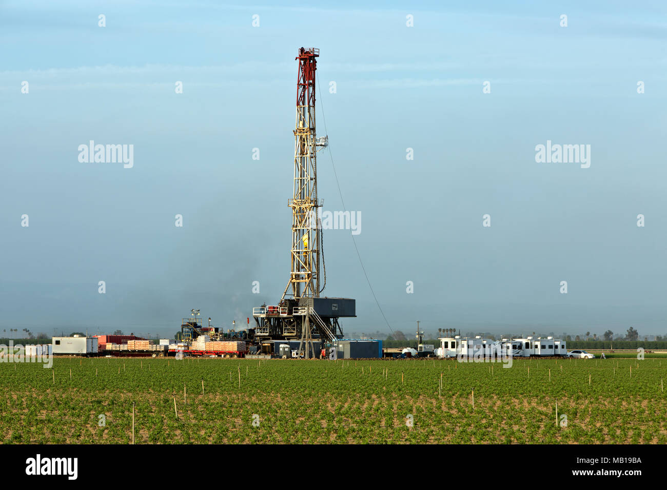 Drilling rig operating in productive tomato field in foreground Stock ...