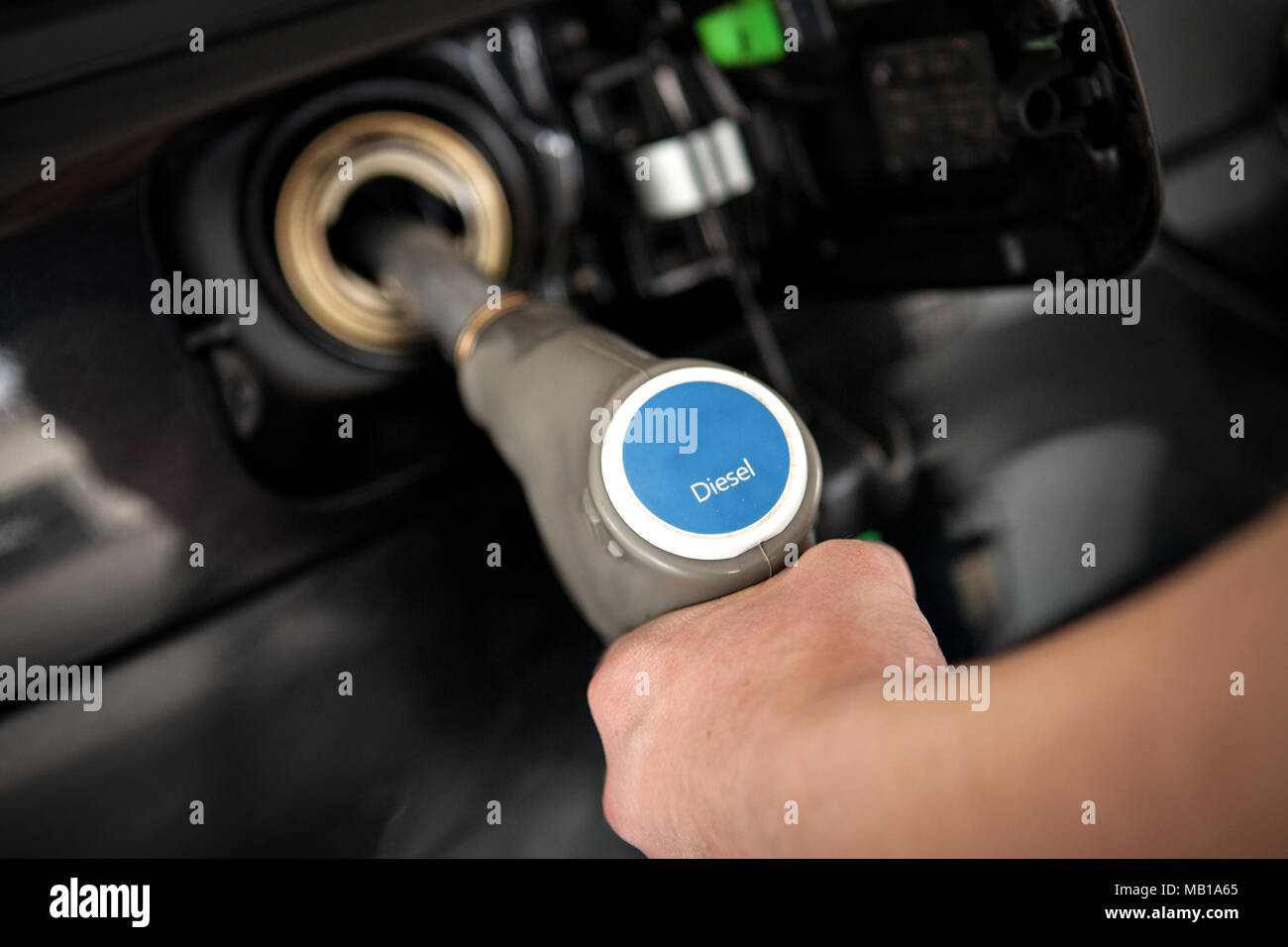 Hand filling tank with diesel at a self service gas station Stock Photo ...