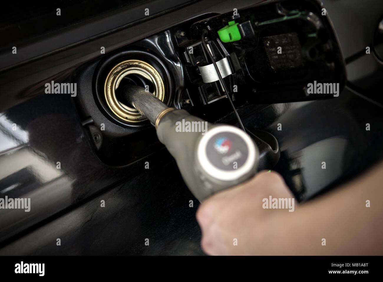 Hand filling tank with diesel at a self service gas station Stock Photo ...