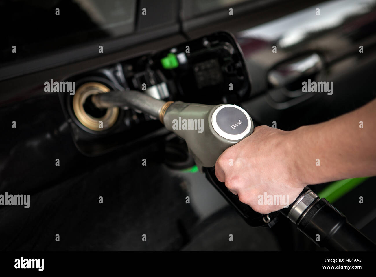 Hand filling tank with diesel at a self service gas station Stock Photo ...