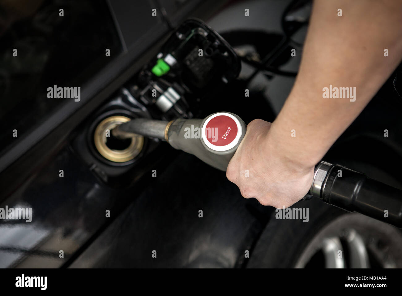 Hand filling tank with diesel at a self service gas station Stock Photo ...