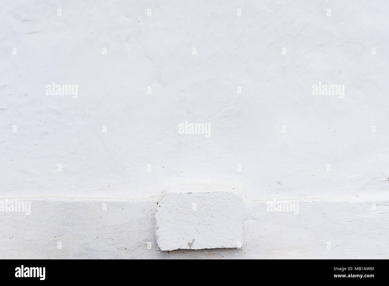 Adobe whitewashed wall in natural white color, dirty, wooden base ...