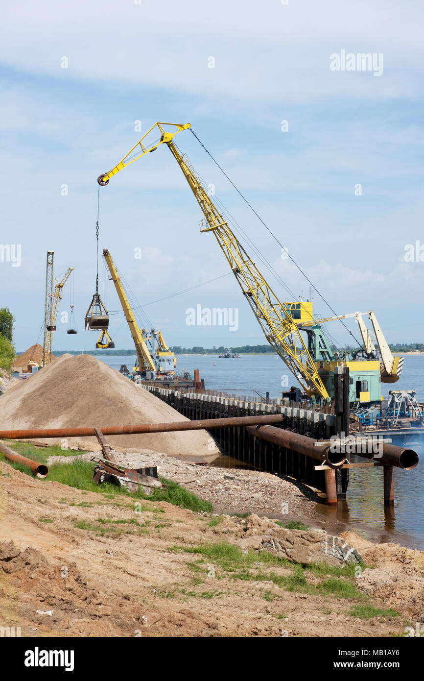 Floating crane scoops soil from the river Stock Photo - Alamy