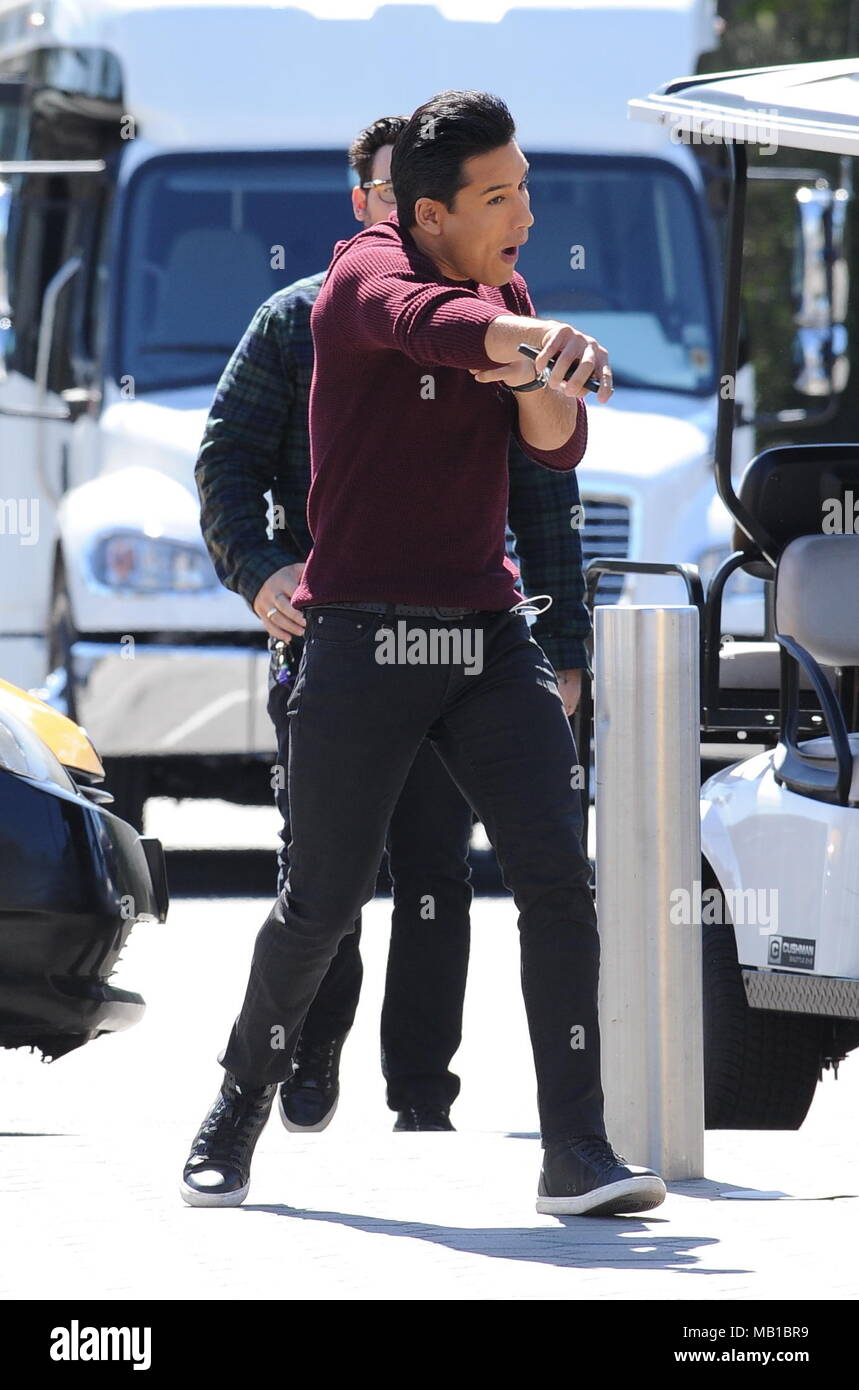 Mario Lopez shows off his boxing moves to a friend on the set of "Extra ...