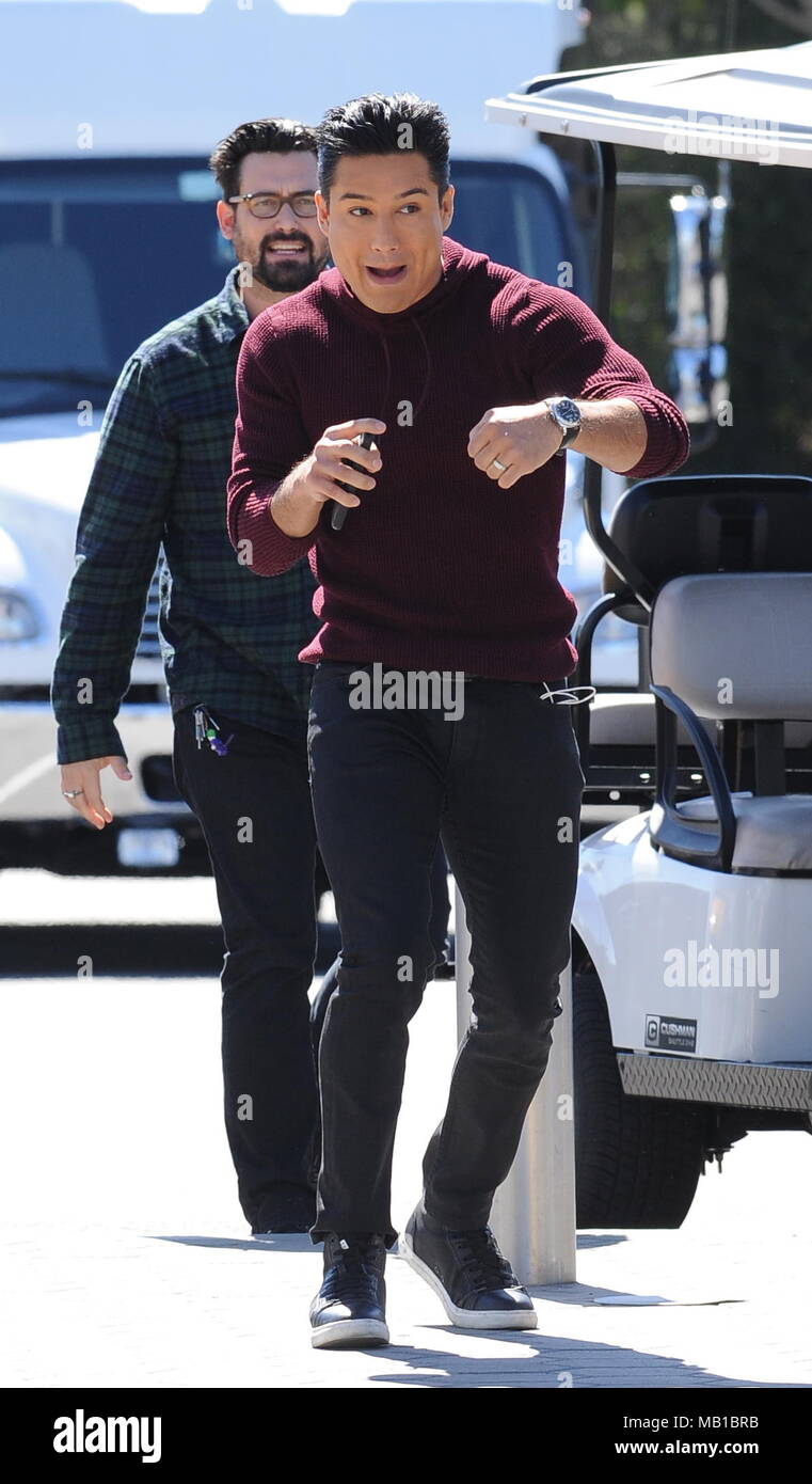 Mario Lopez shows off his boxing moves to a friend on the set of "Extra ...