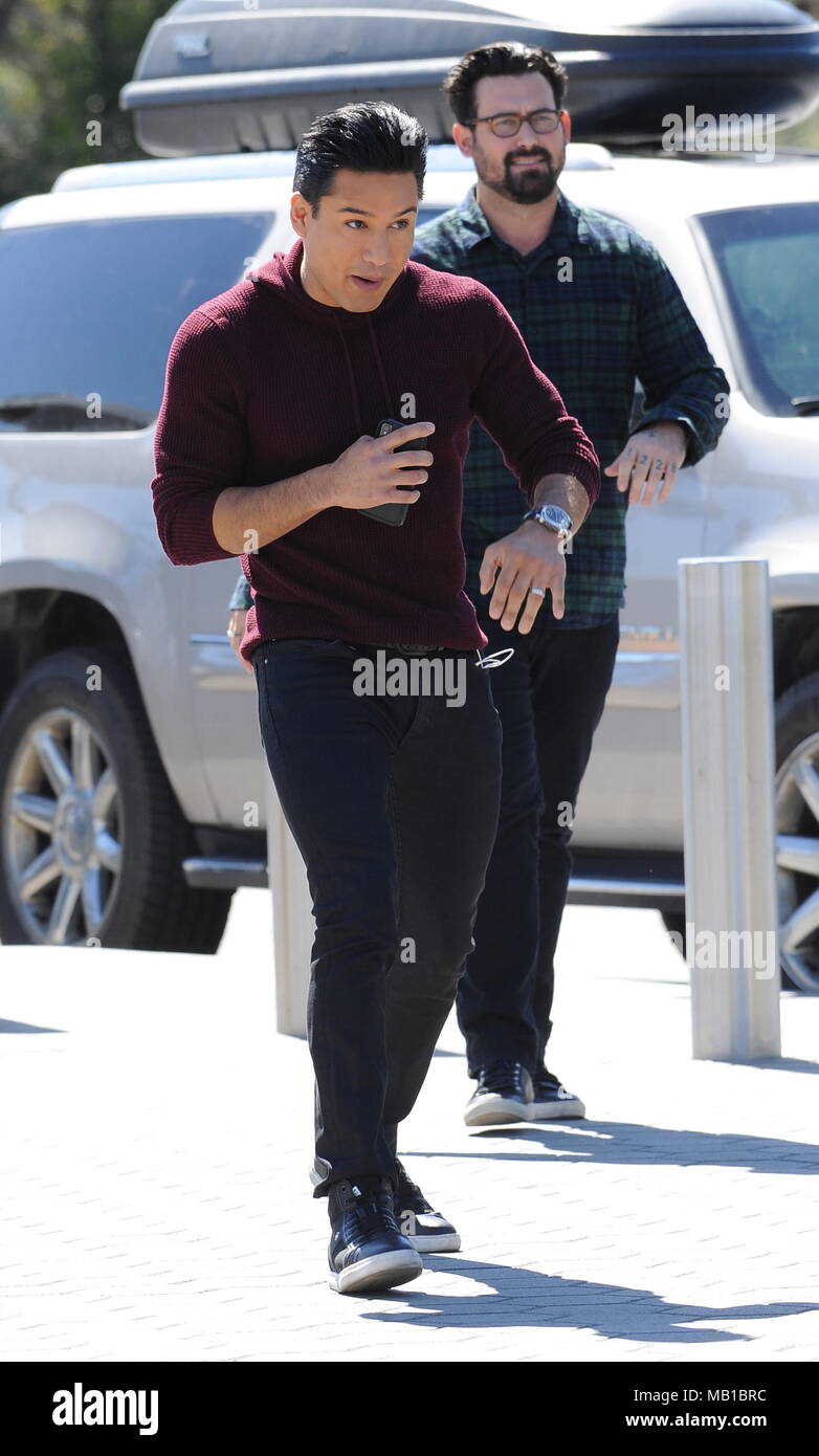 Mario Lopez shows off his boxing moves to a friend on the set of "Extra ...