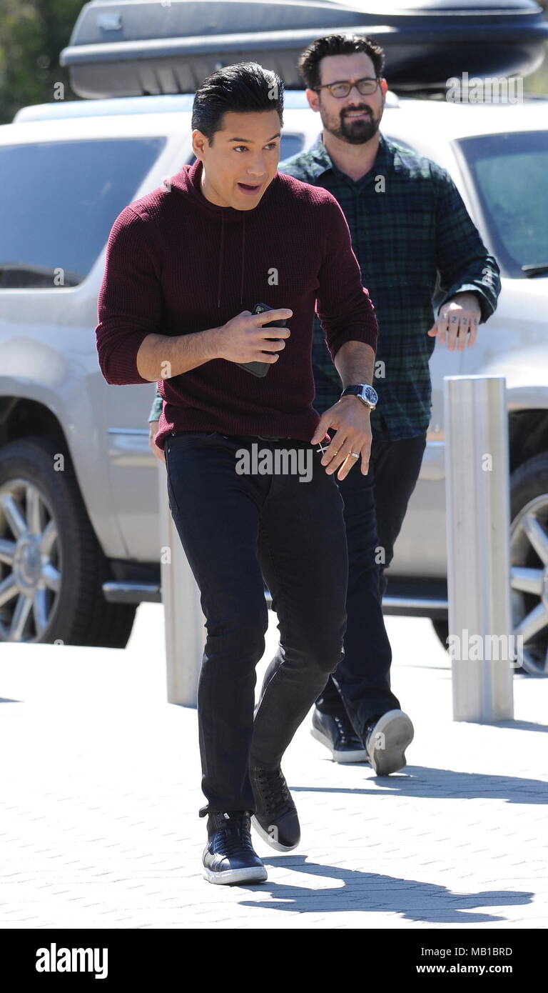 Mario Lopez shows off his boxing moves to a friend on the set of "Extra ...