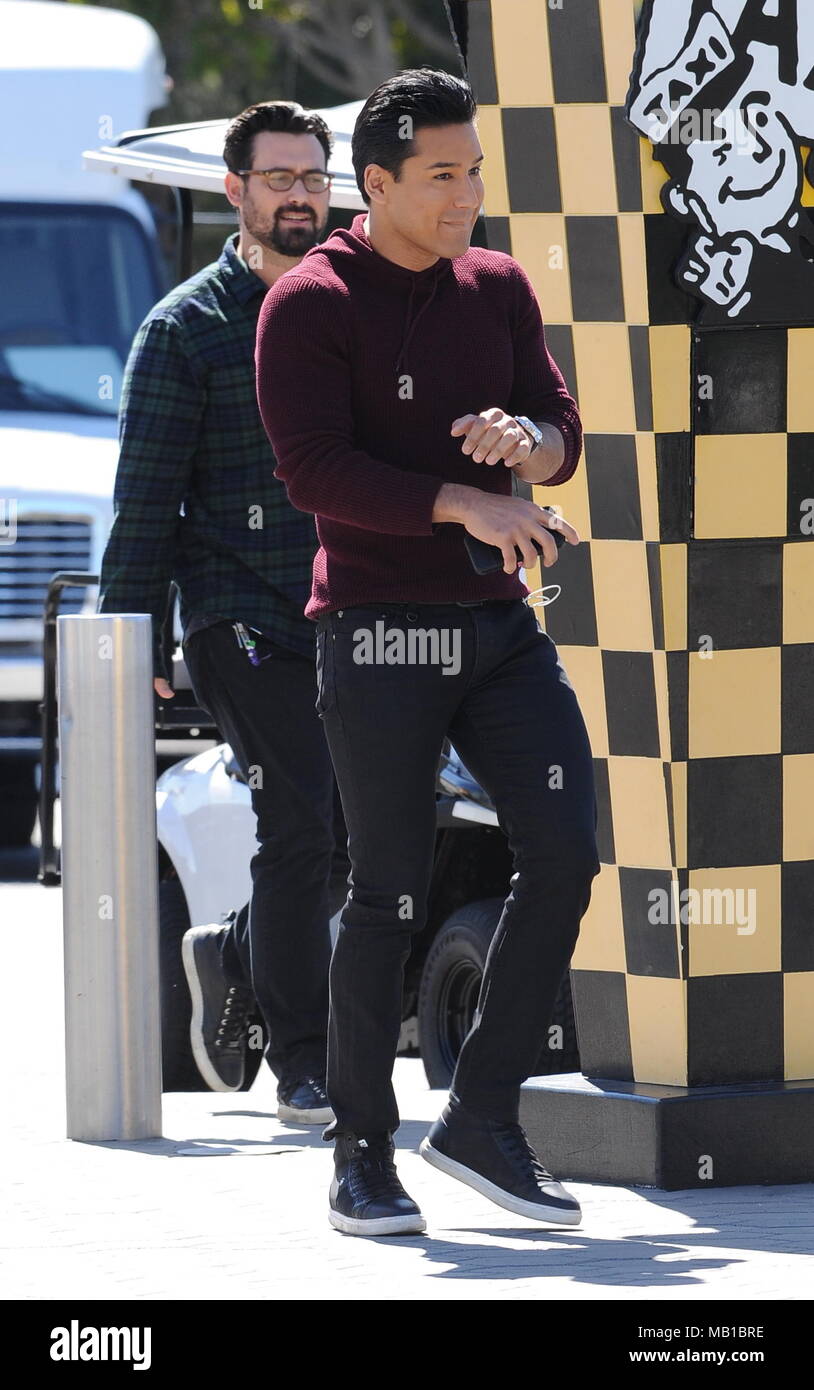 Mario Lopez shows off his boxing moves to a friend on the set of "Extra ...