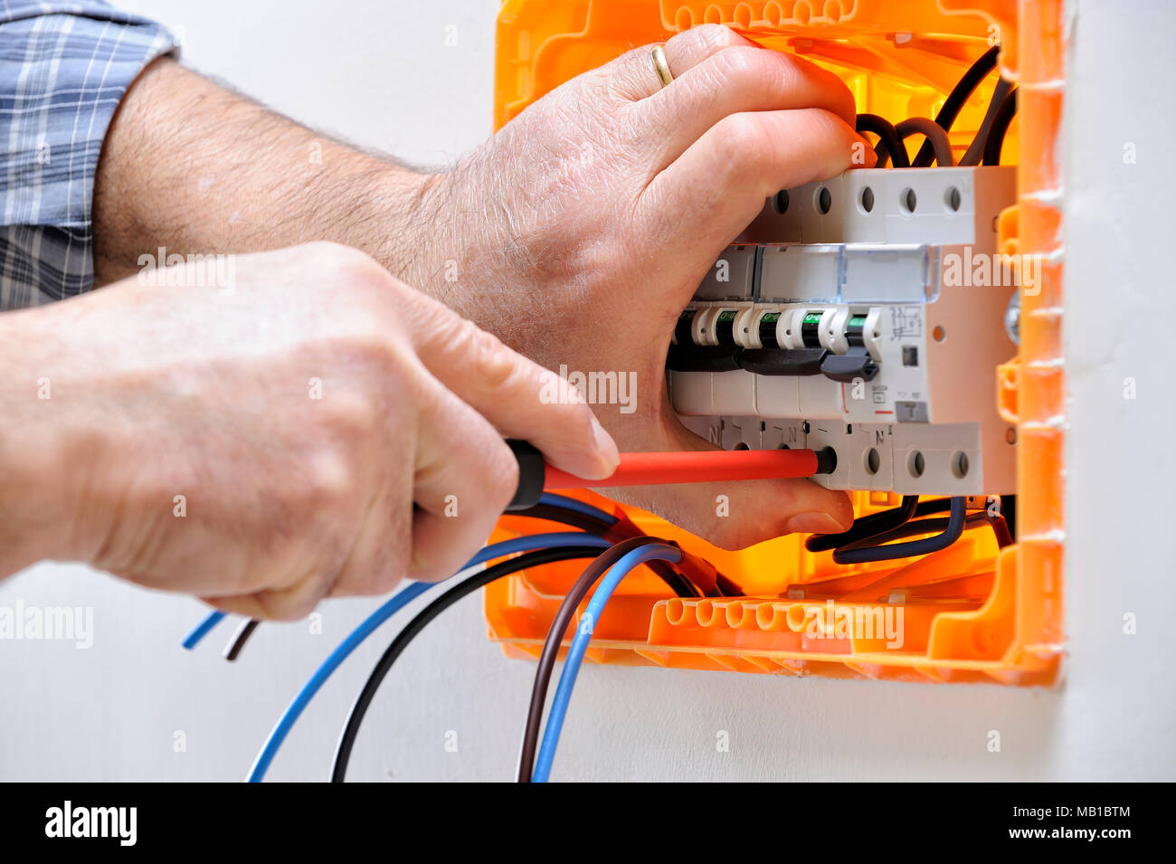 Electrician technician working on a residential electrical panel ...