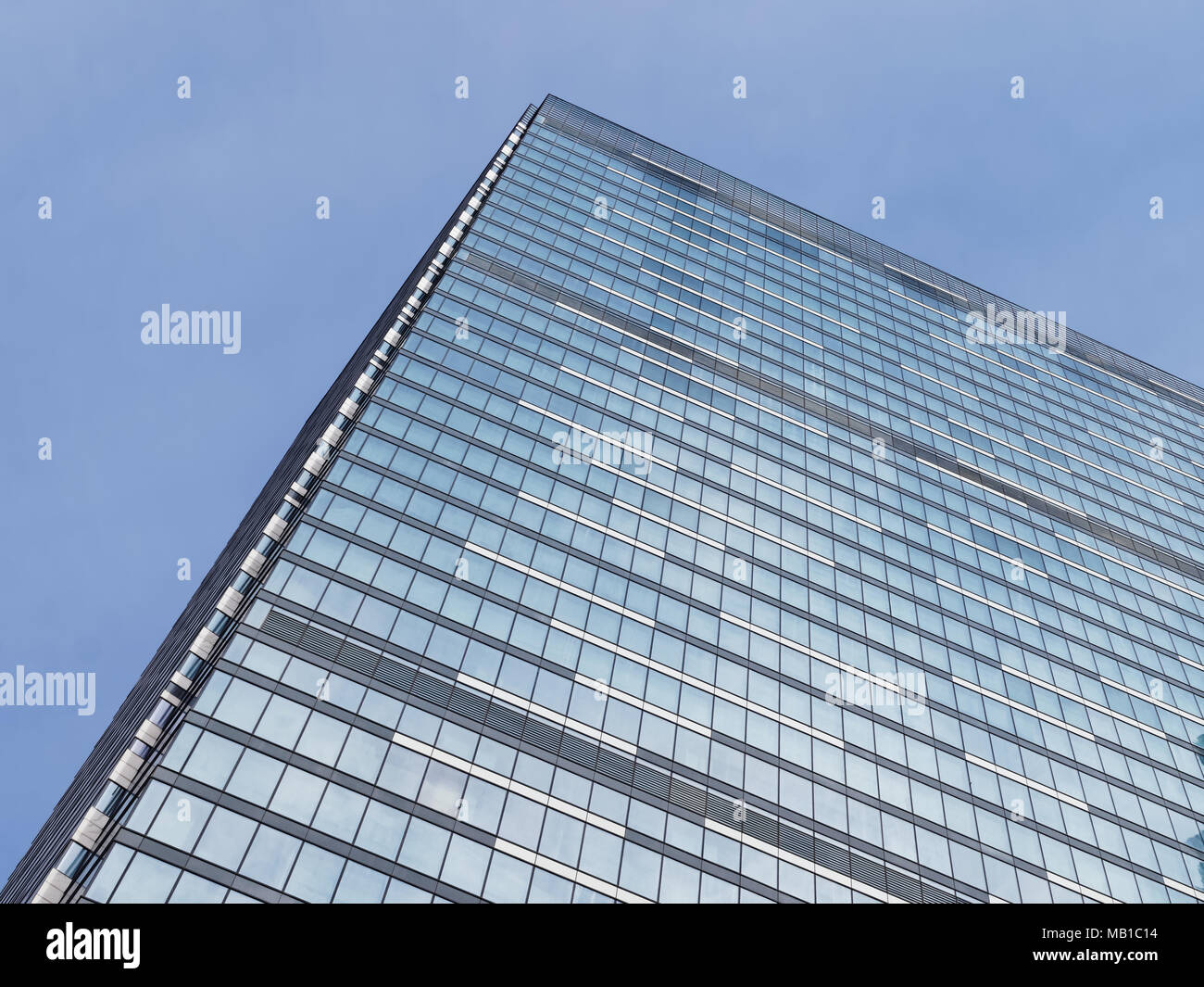 Skyscraper with glass facade, angle view creates interesting urban ...