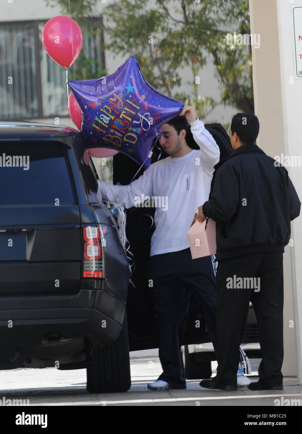 Zack Bia the boyfriend of model Madison Beer holding a handful of ...
