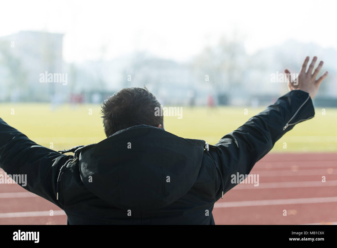 Back View of Young Man Sitting on Seat or Bleachers Sports Tribune and ...